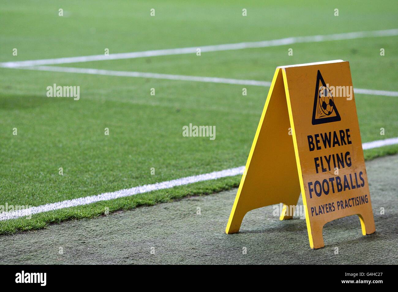 Football players practising warning sign grass pitch hi-res stock ...