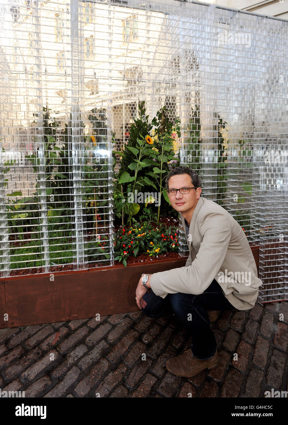 Award winning designer Sebastian Bergne kneels in front of his fully ...