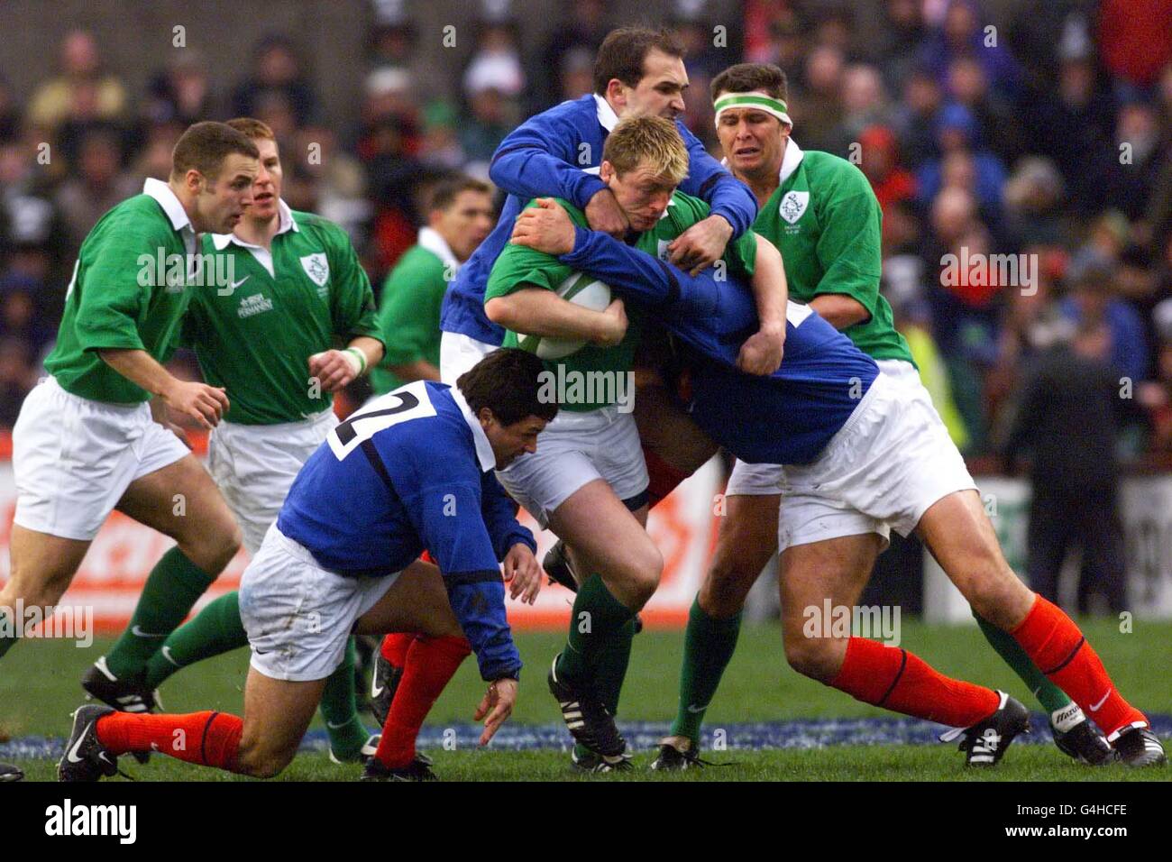 Ireland's flanker Eric Miller fights his way through a French tackle ...
