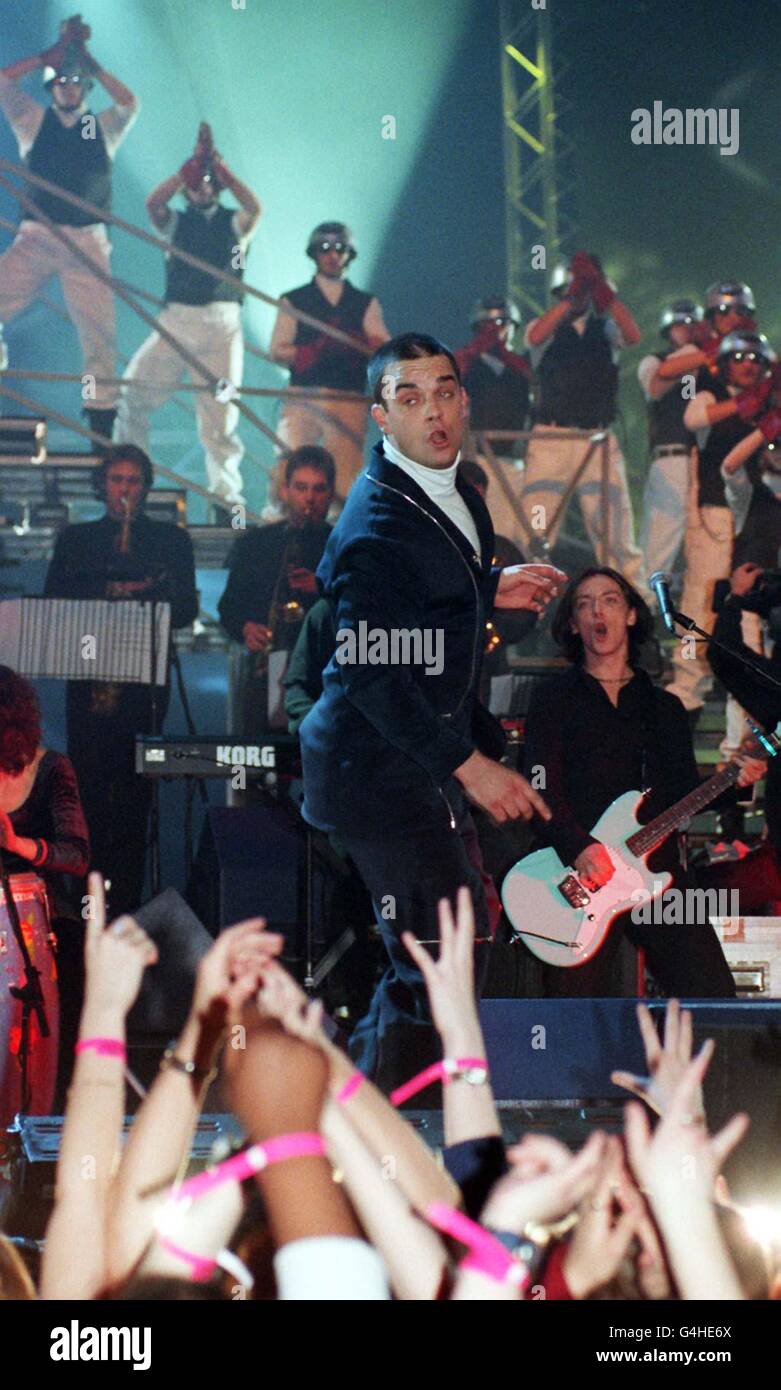 Robbie Williams performs at the Brit Awards, at the London Arena Stock ...