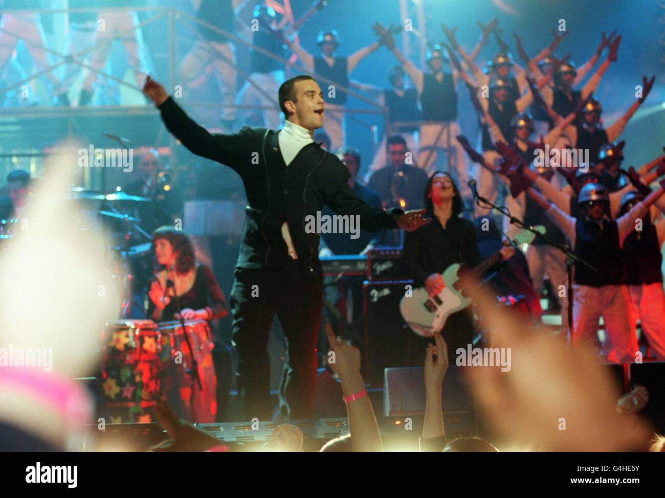 Robbie Williams performs at the Brit Awards, at the London Arena Stock ...