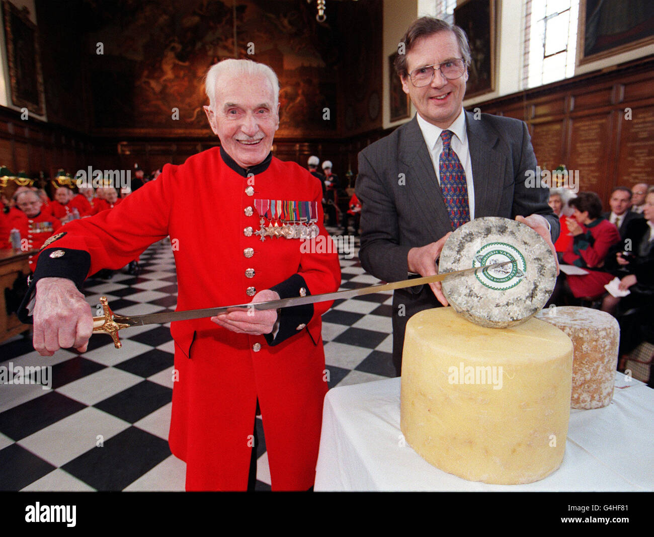 Chelsea pensioner archie harrington slices a 10lb cornish yarg cheese ...
