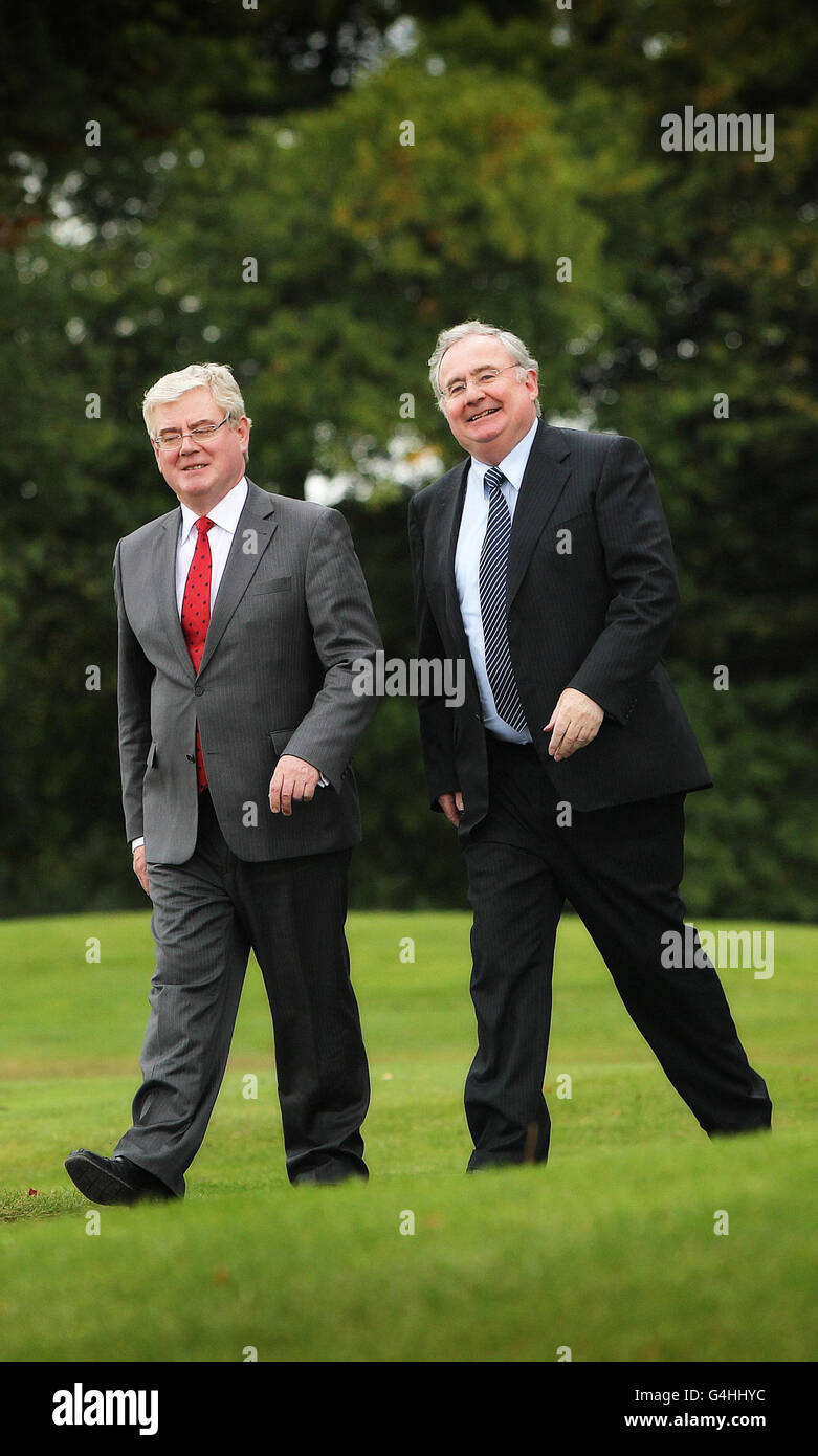 Labour leader Eamon Gilmore (left) and TD Pat Rabbitte walk on the golf ...