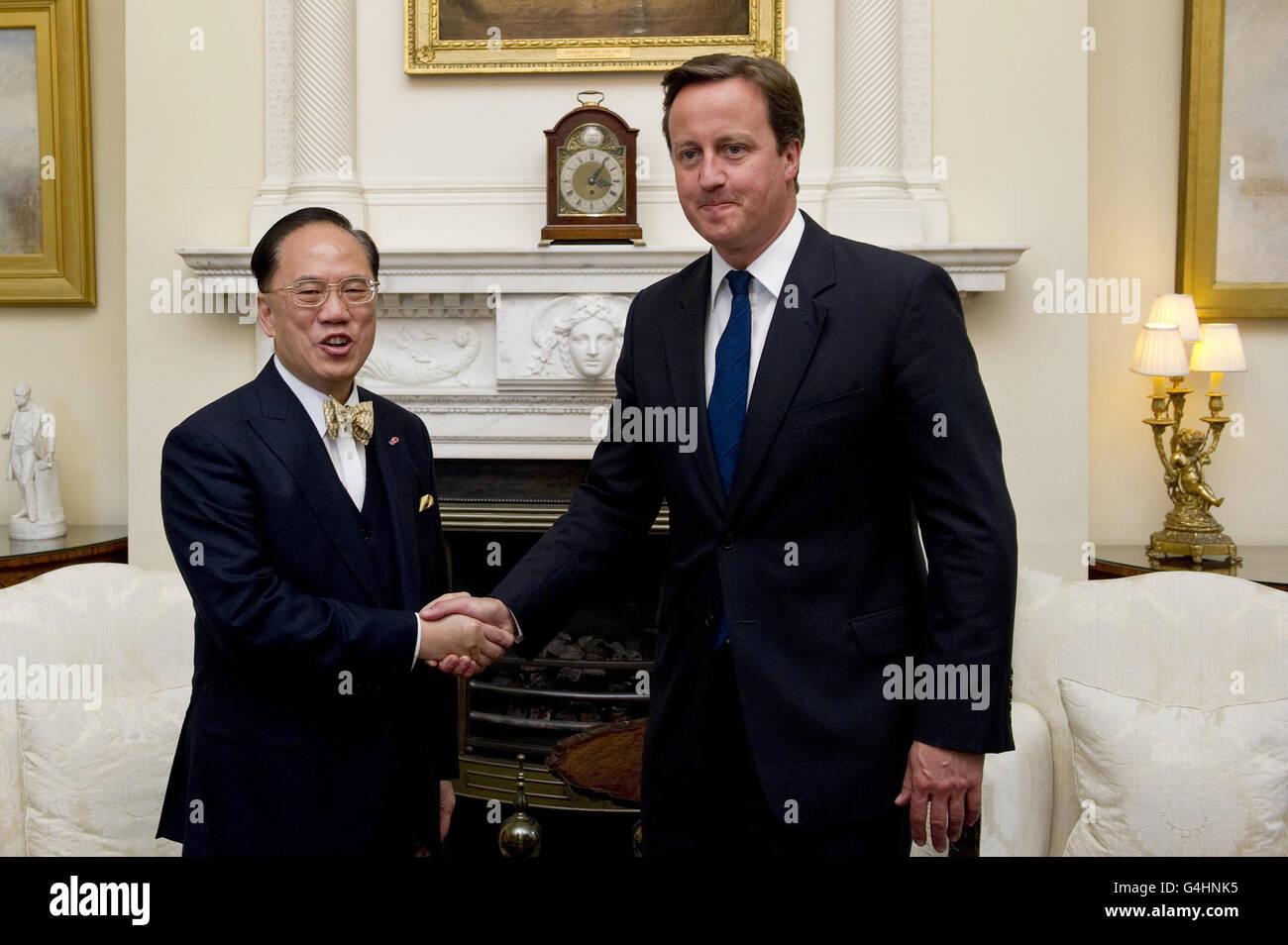 Prime Minister David Cameron (right) shakes hands with Hong Kong Chief ...