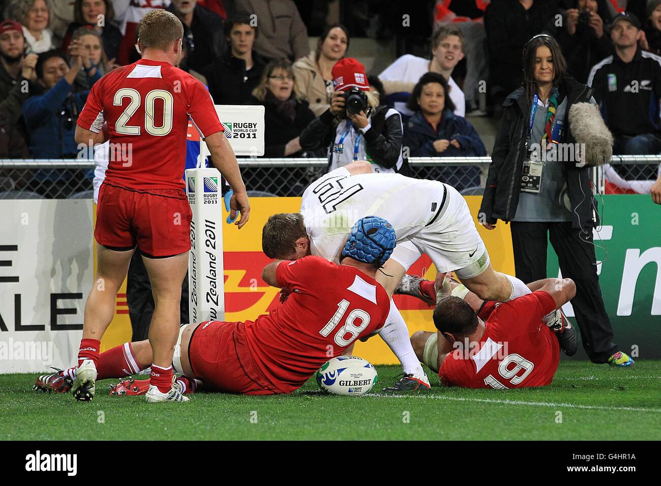 Georgia's Levan Datunashvili (centre, number 18) goes in on England's ...