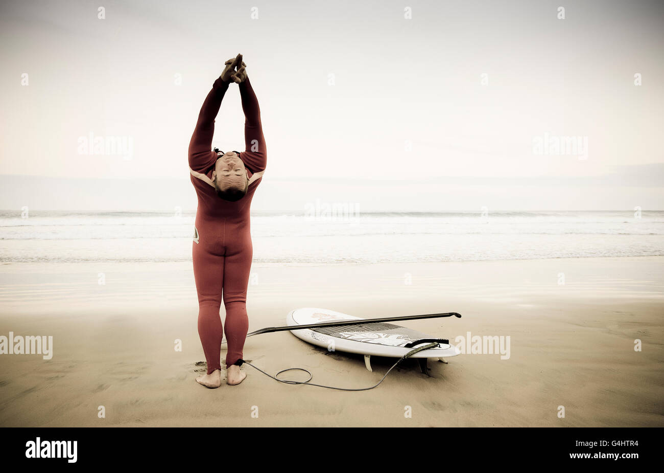 Stand up paddle boarder doing warm up exercises Stock Photo - Alamy