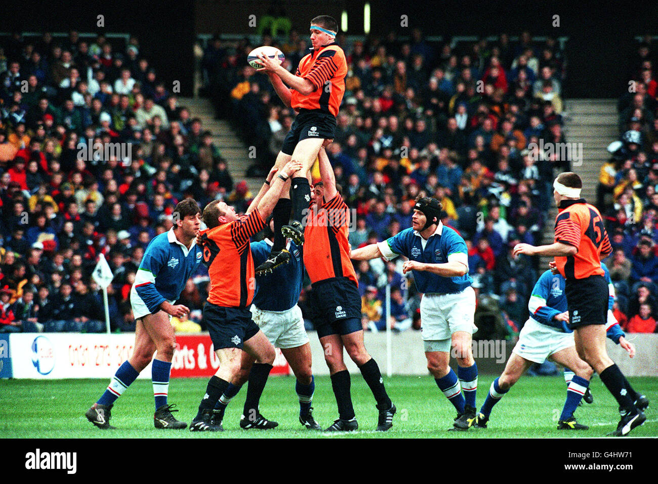 Scotland's Scott Murray is held high by team-mates, enabling him to ...