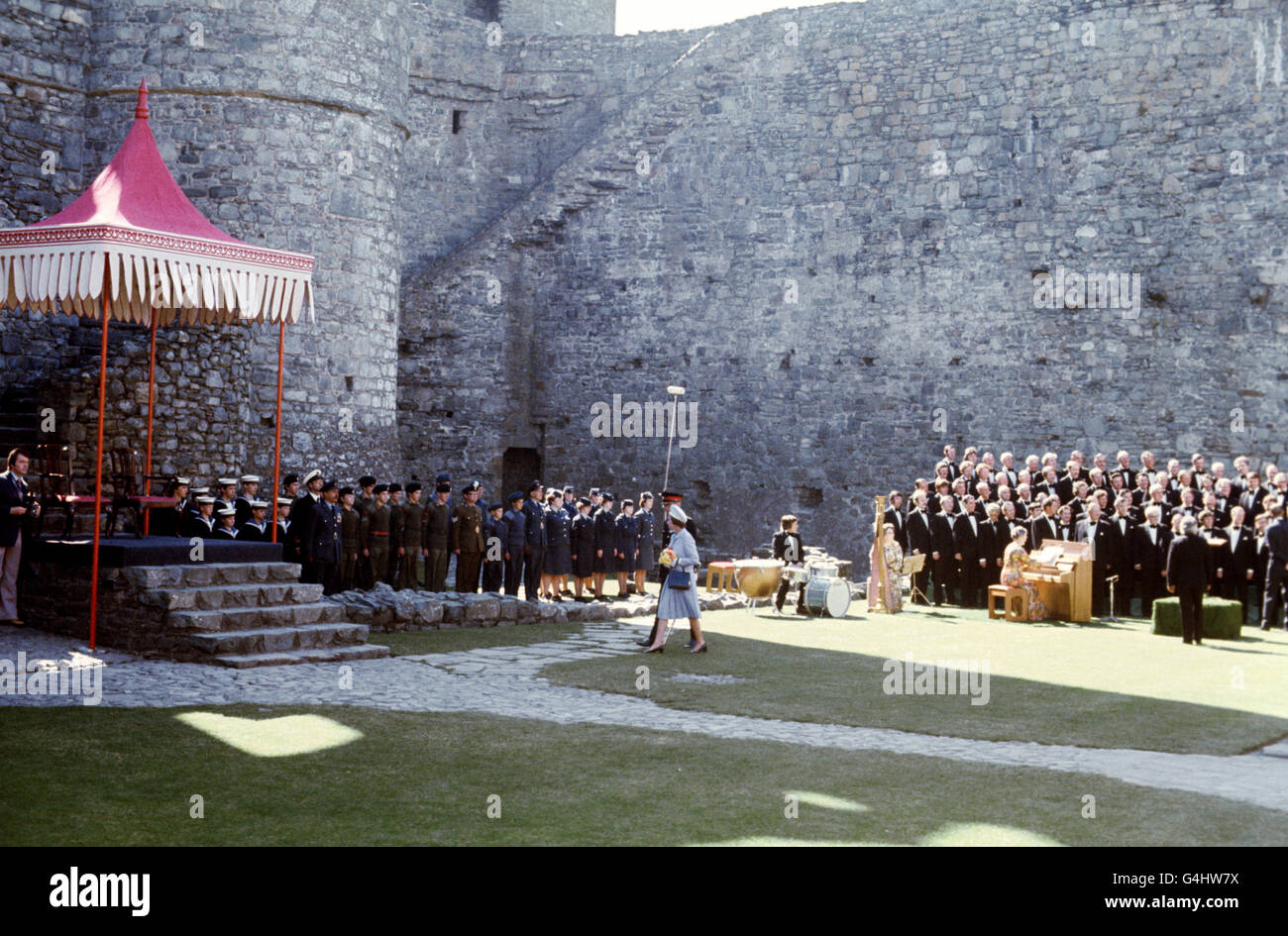 Queen Elizabeth walking to a dais at Harlech Castle, with a male voice ...