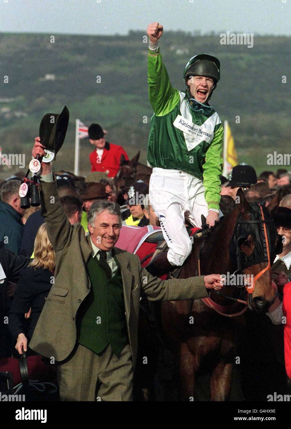 Jockey Mick Fitzgerald punches as he is led in to the winners enclosure ...