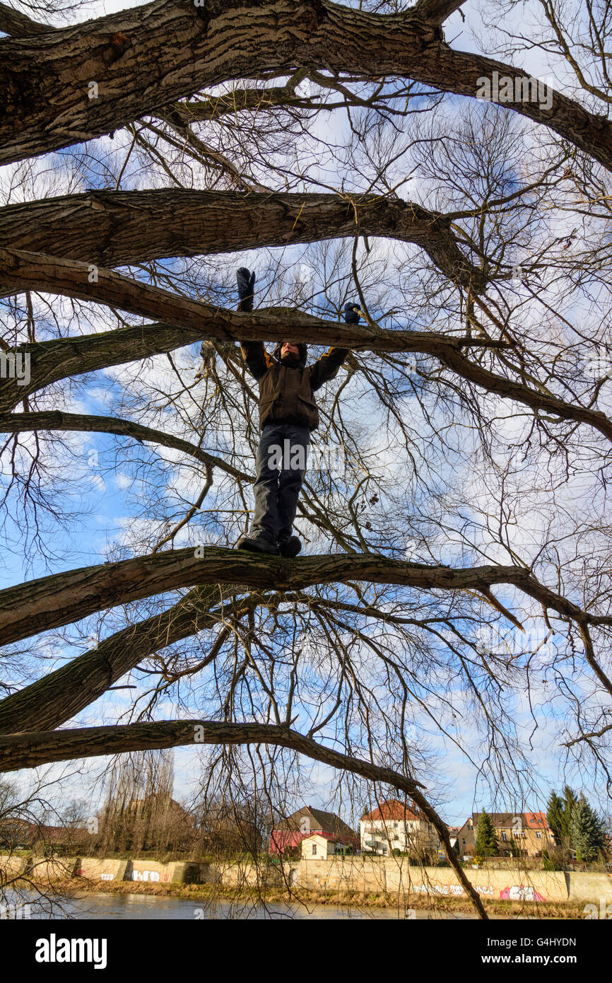 Child climbing tree hi-res stock photography and images - Alamy