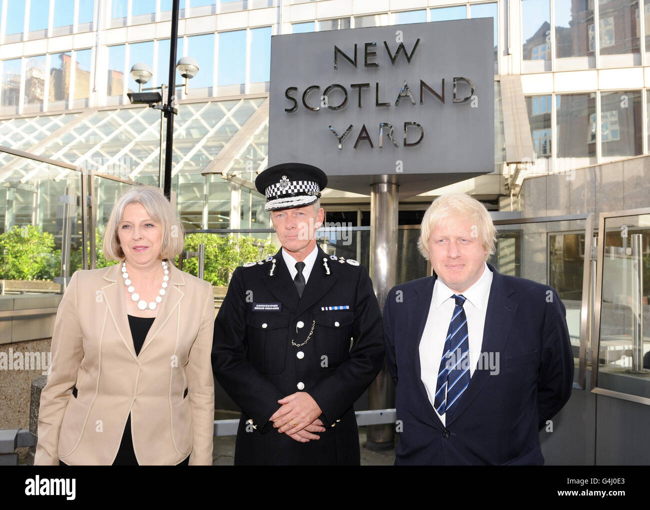 New Metropolitan Police Commissioner Bernard Hogan-Howe (centre) stands ...