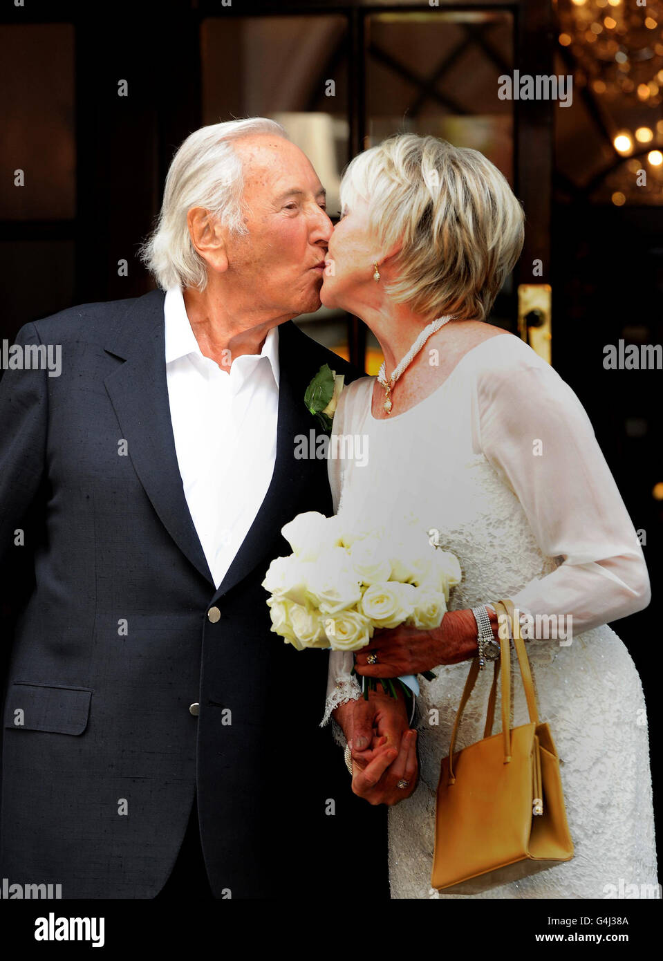 Michael Winner and wife Geraldine kiss as they pose for media following ...