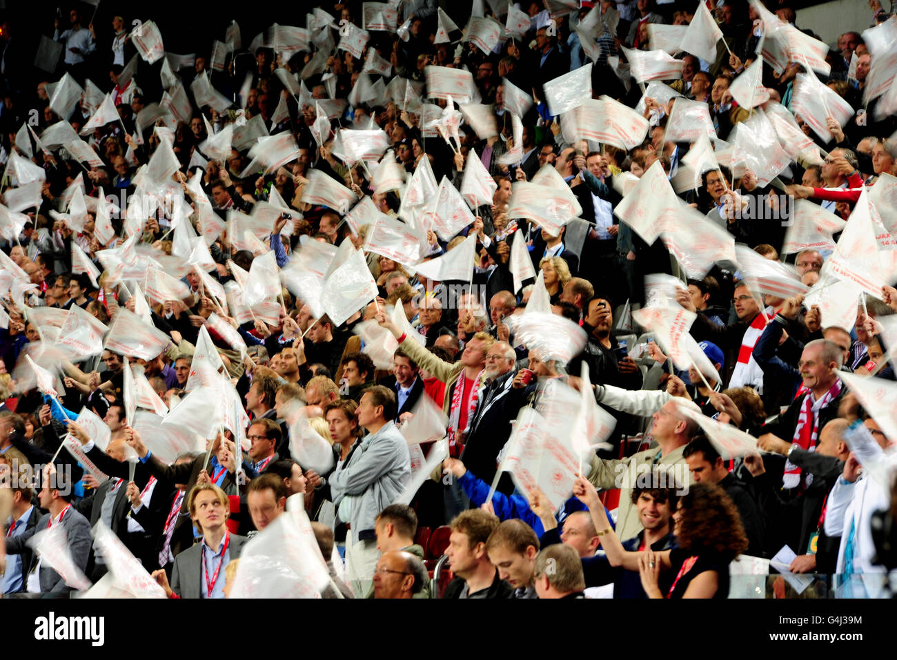 Ajax fans cheer on their side by waving flags in the stands Stock Photo ...