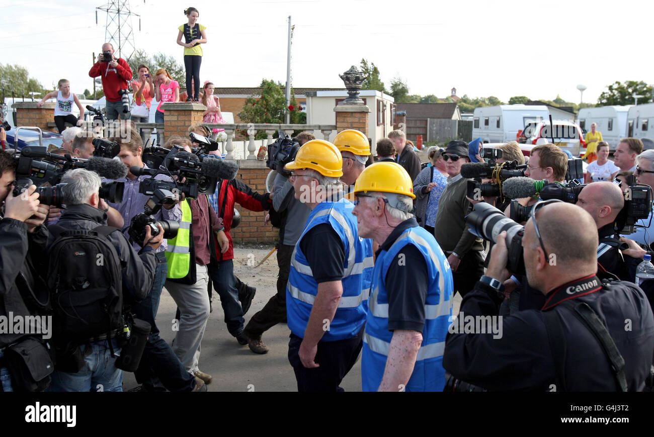 Bailiff officers from Constant & Co make their way up to the gate of ...