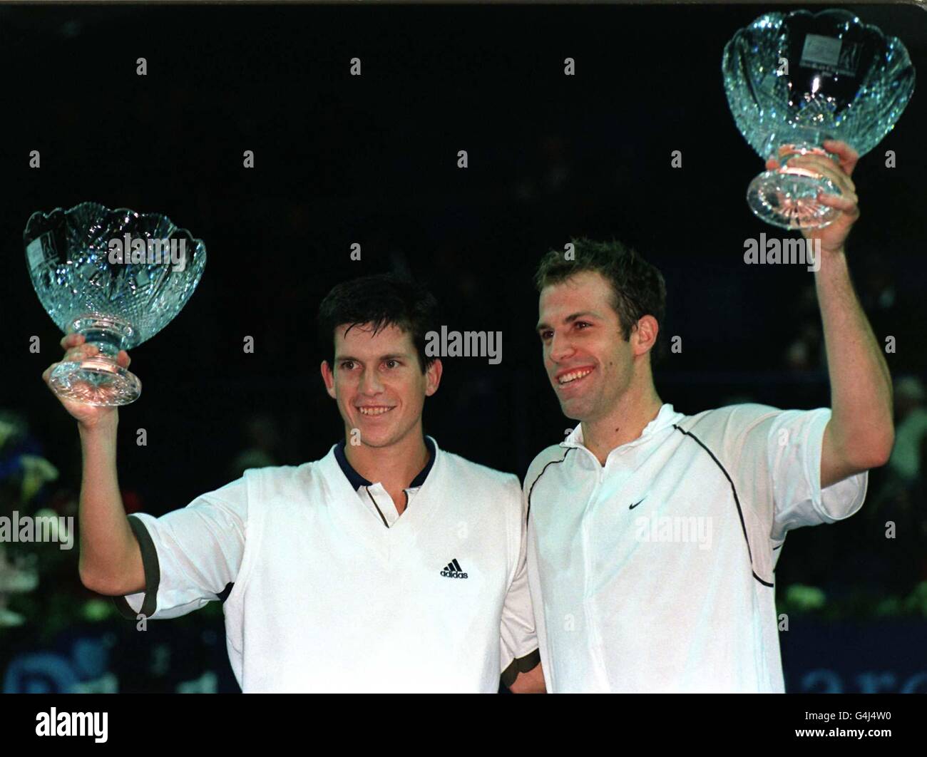 Britain's Tim Henman (left) & Greg Rusedski hold their trophies aloft ...