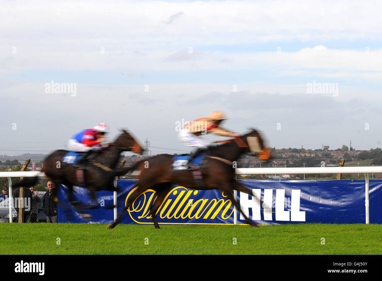 Blurred action of Jockey Paul Hanagan on Silvanus (right) and Patrick ...