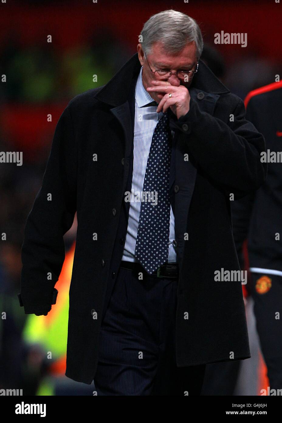 Manchester United manager Sir Alex Ferguson walks down the touchline ...
