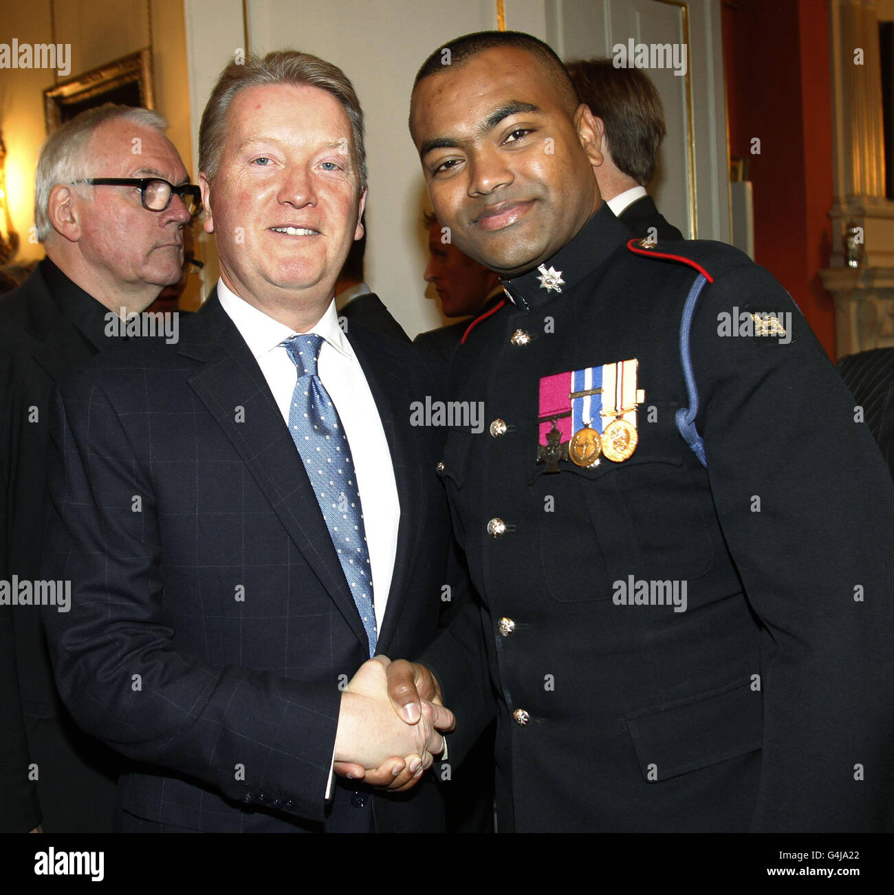 Frank Warren shakes the hand of Lance Corporal Johnson Beharry VC ...