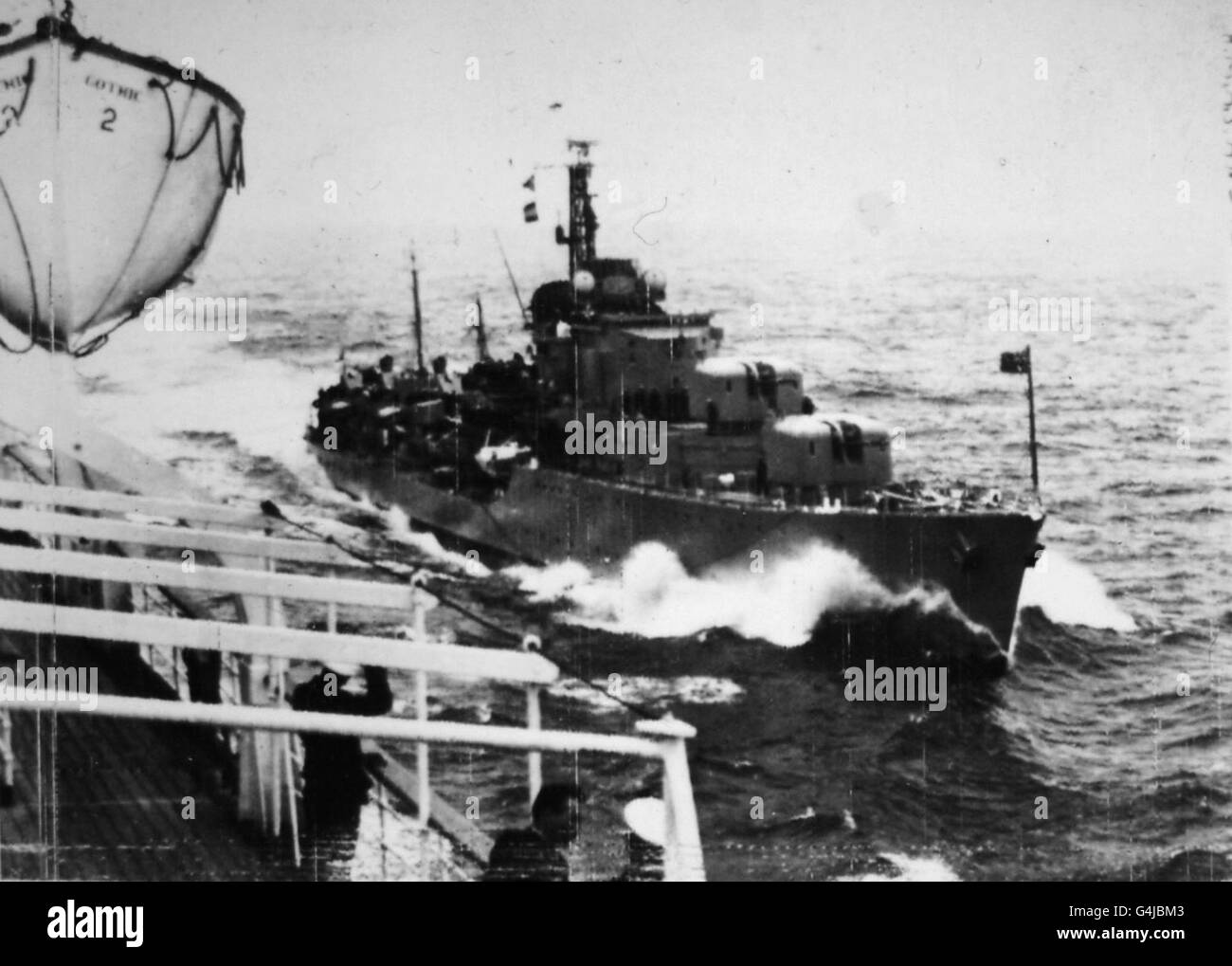 The Australian destroyer ANZAC speeding alongside the Royal tour ship ...