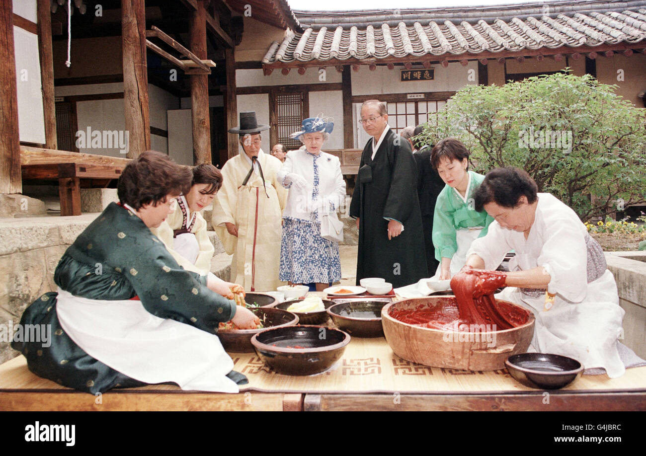 The Queen who is 73 is shown Kimchi, a cabbage dish, being prepared in ...