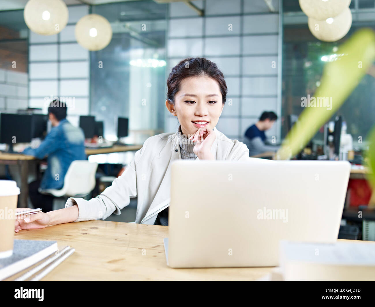 young asian business woman working in office using laptop computer ...