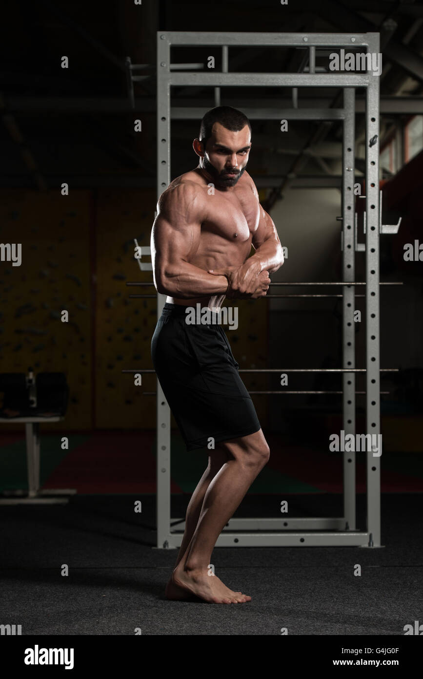 Portrait Of A Young Physically Fit Man Performing Side Chest Pose ...