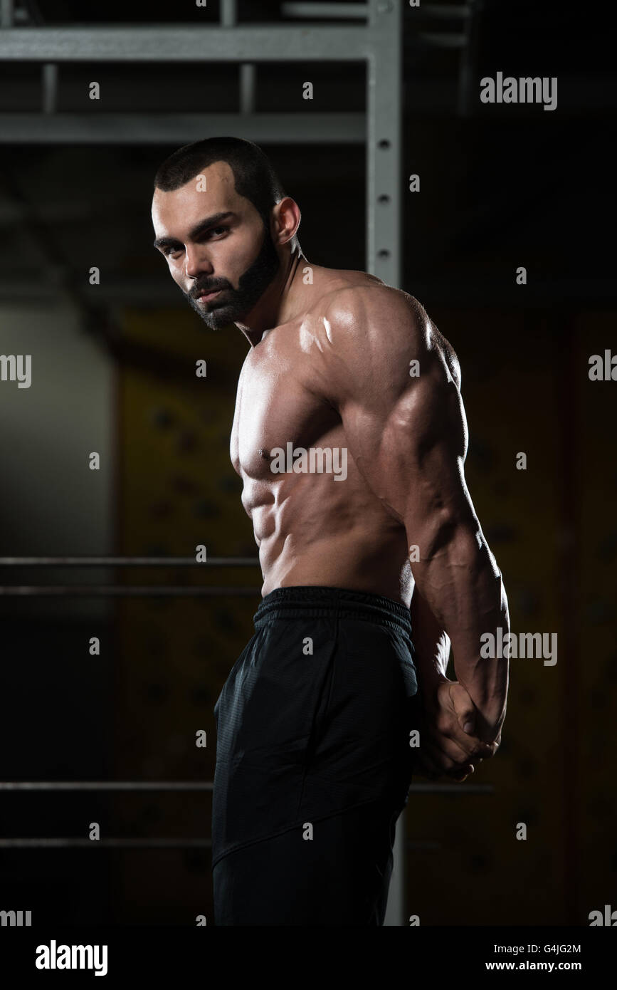 Portrait Of A Young Fit Man Showing Side Triceps Pose - Muscular ...