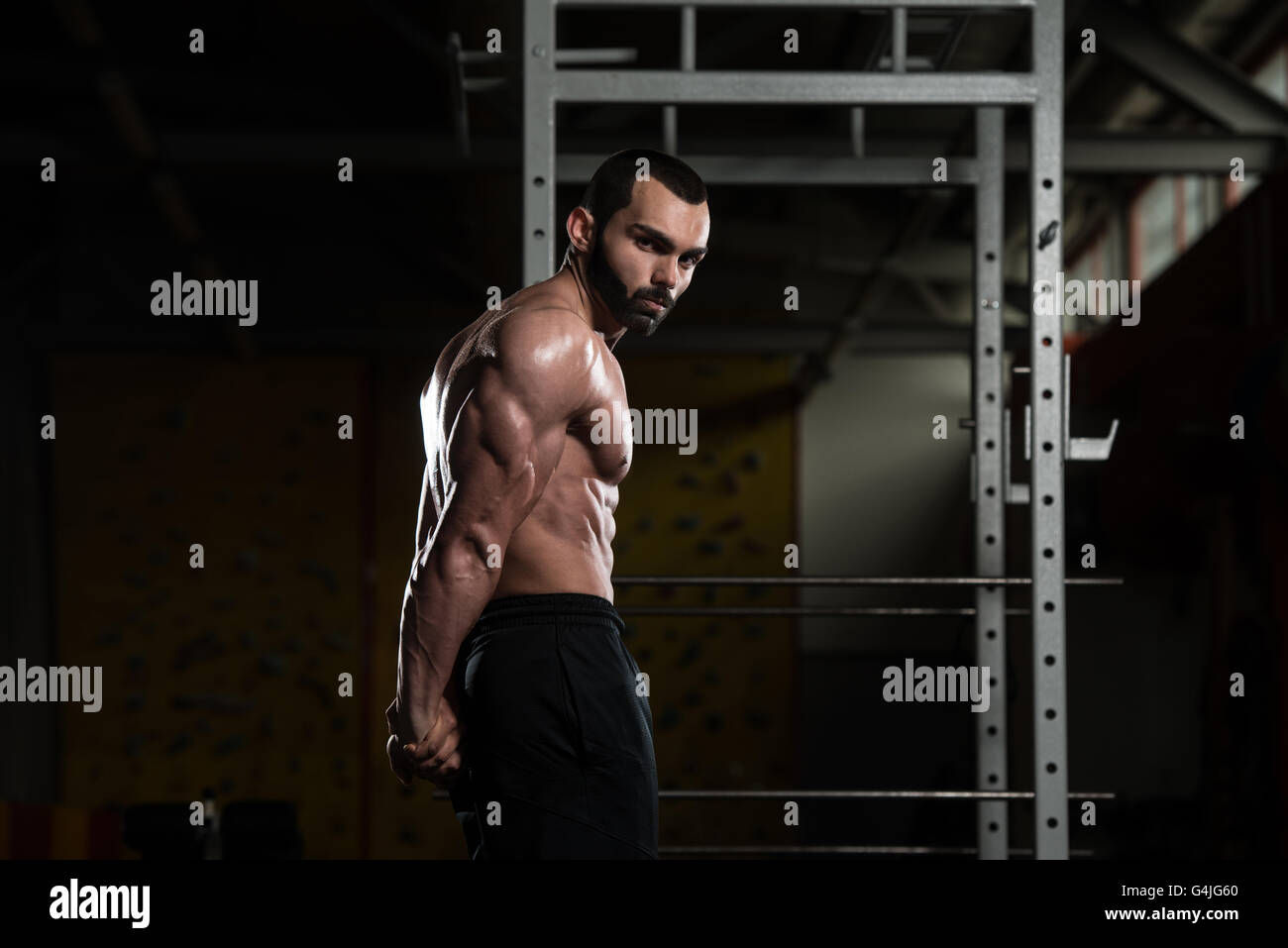 Male bodybuilder flexing muscles side hi-res stock photography and ...