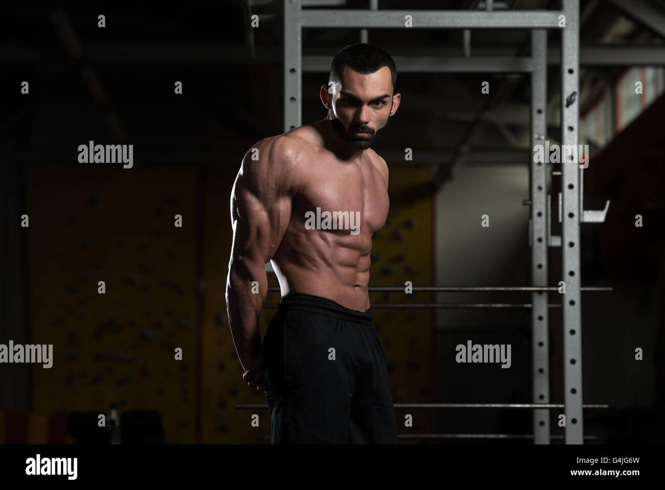 Male bodybuilder flexing muscles side hi-res stock photography and ...