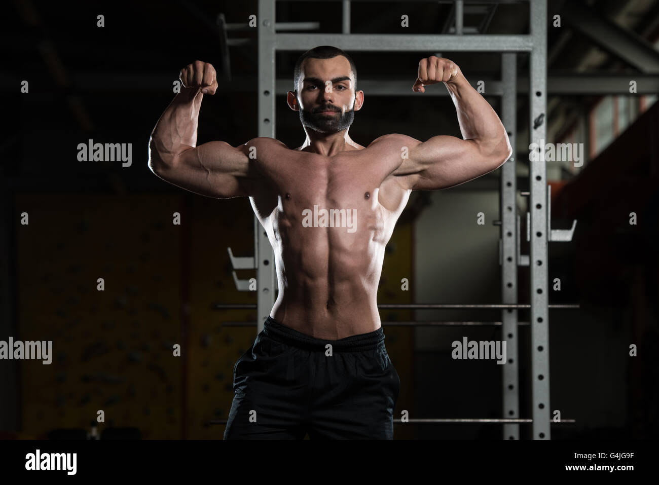 Portrait Of A Young Fit Man Performing Front Double Biceps Pose ...