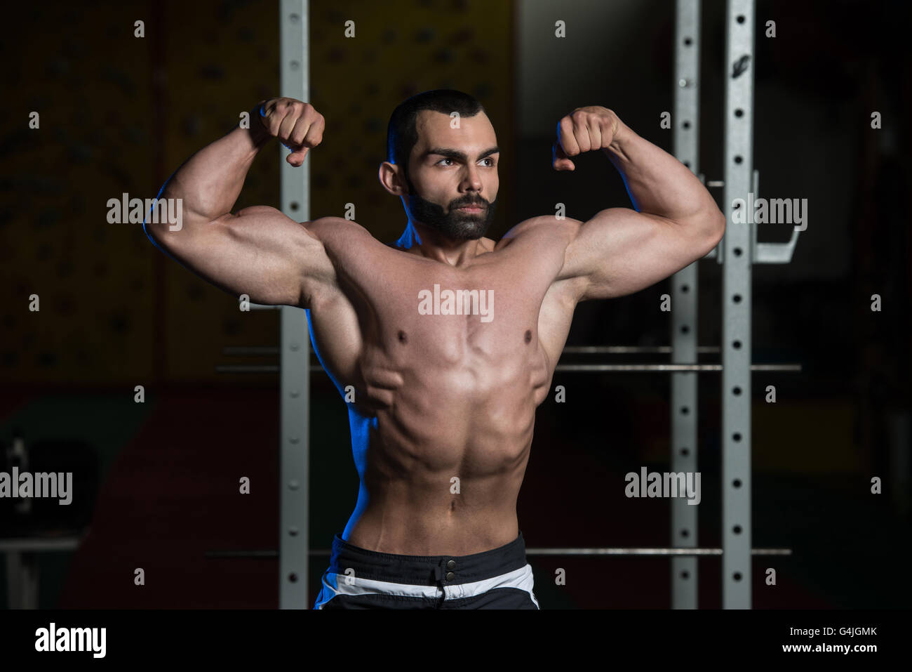 Portrait Of A Young Fit Man Showing Front Double Biceps Pose - Muscular ...