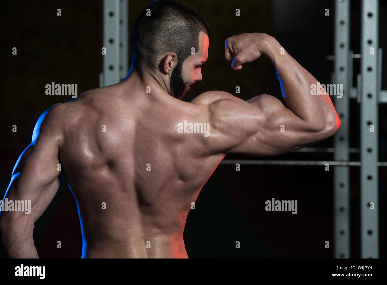 Portrait Of A Young Fit Man Flexing Front Biceps Pose - Muscular ...