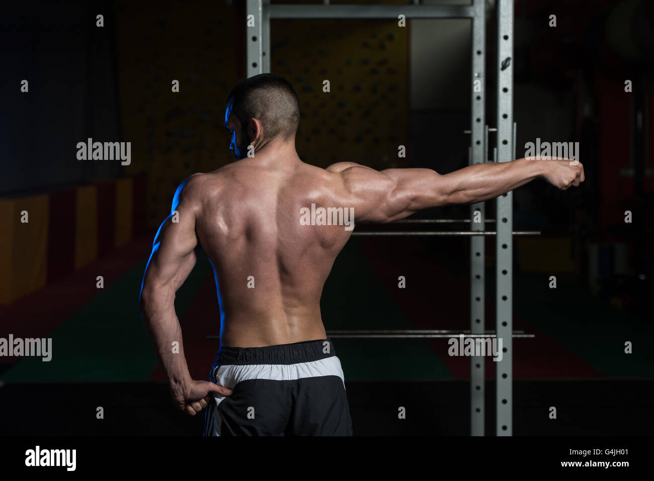 Portrait Of A Young Fit Man Flexing Front Biceps Pose - Muscular ...