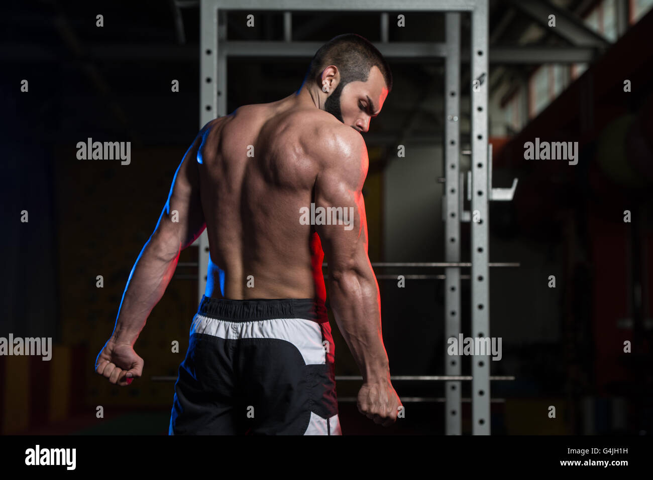 Portrait Of A Young Fit Man Showing Side Triceps Pose - Muscular ...