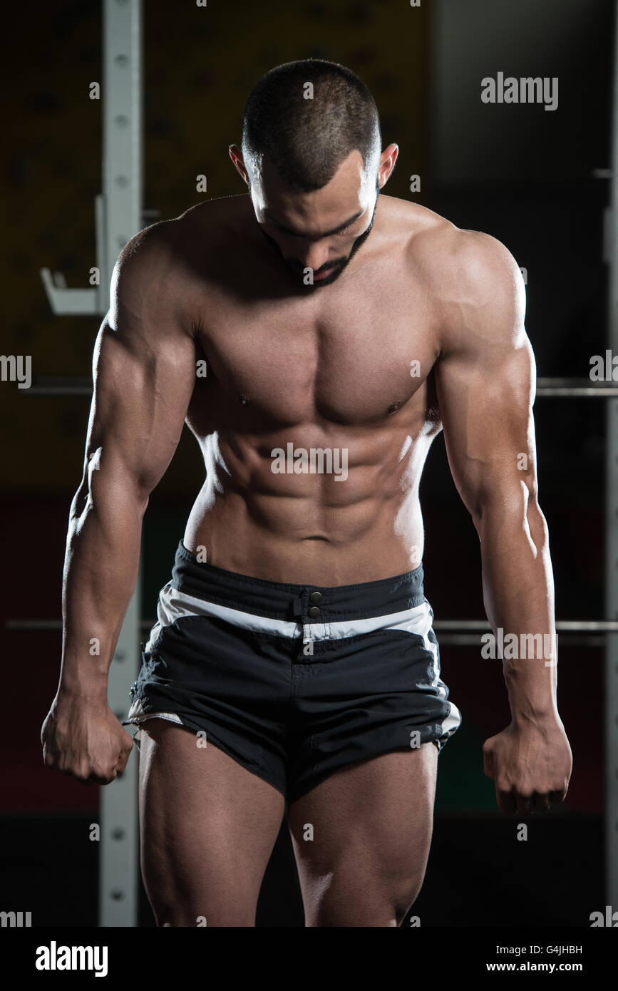 Portrait Of A Young Physically Fit Man Making Most Muscular Pose ...