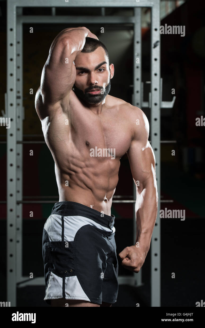 Portrait Of A Young Physically Fit Man Showing His Well Trained ...