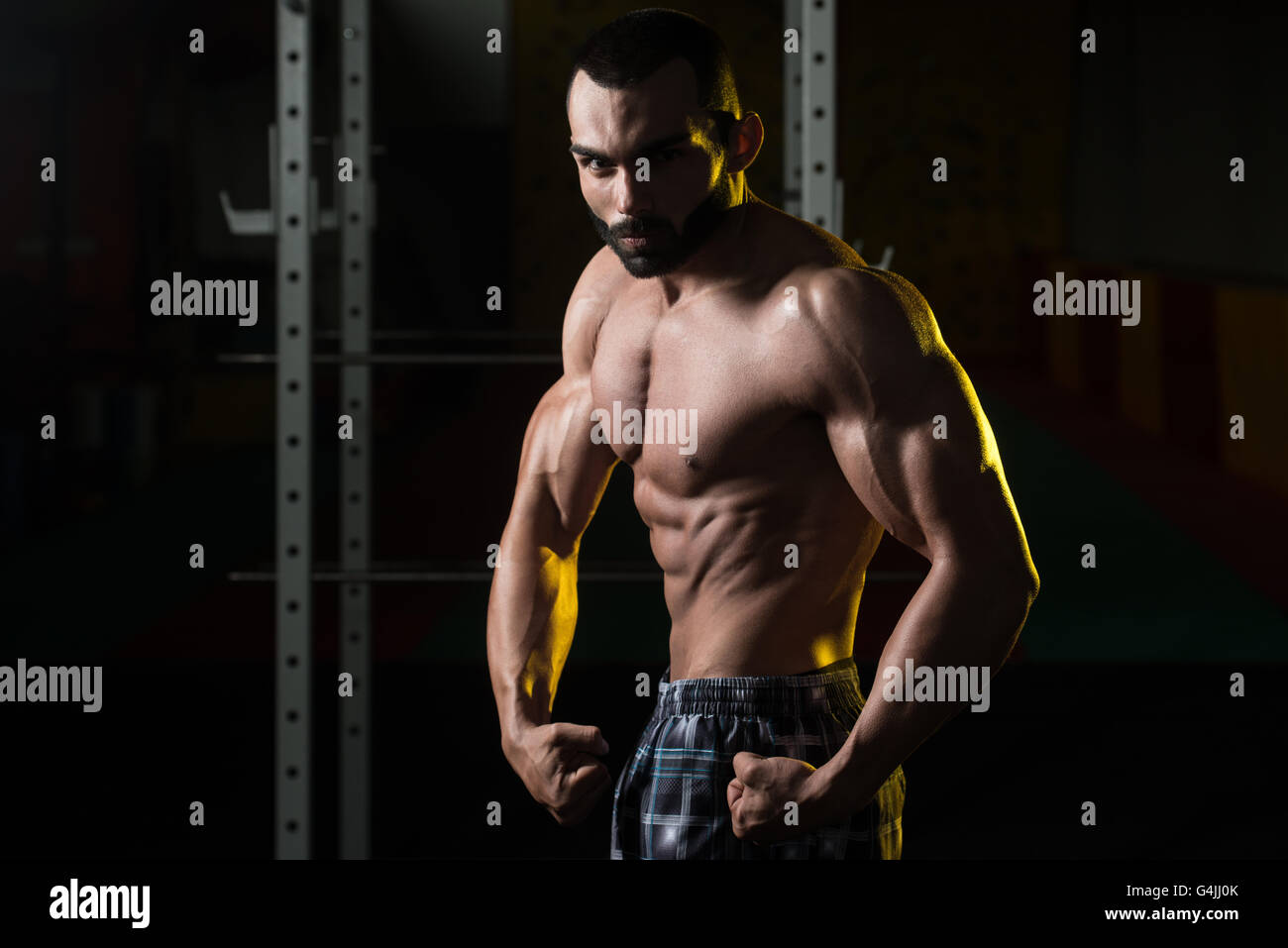 Portrait Of A Young Physically Fit Man Performing Side Chest Pose ...