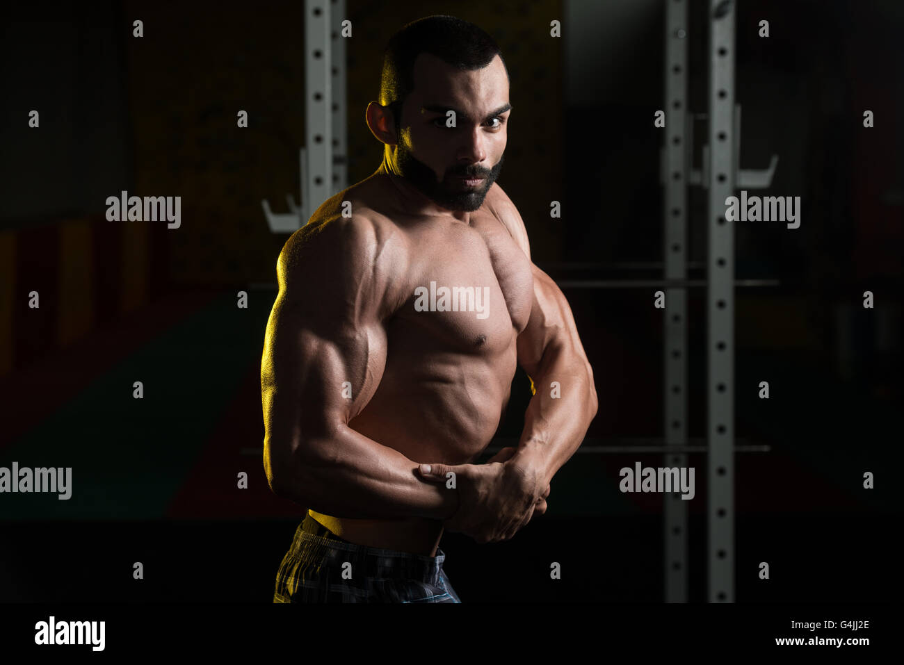 Portrait Of A Young Physically Fit Man Performing Side Chest Pose ...