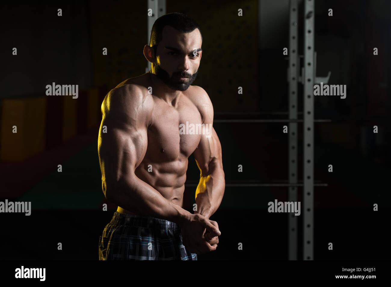 Portrait Of A Young Physically Fit Man Making Most Muscular Pose ...