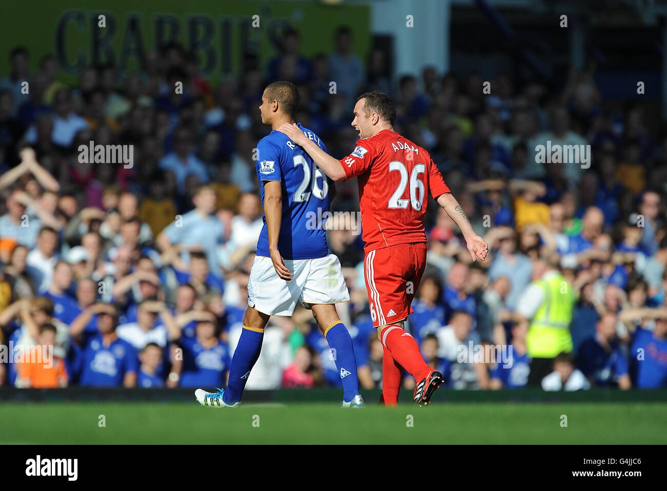 Everton's Jack Rodwell (left) is consoled by Liverpool's Charlie Adam ...