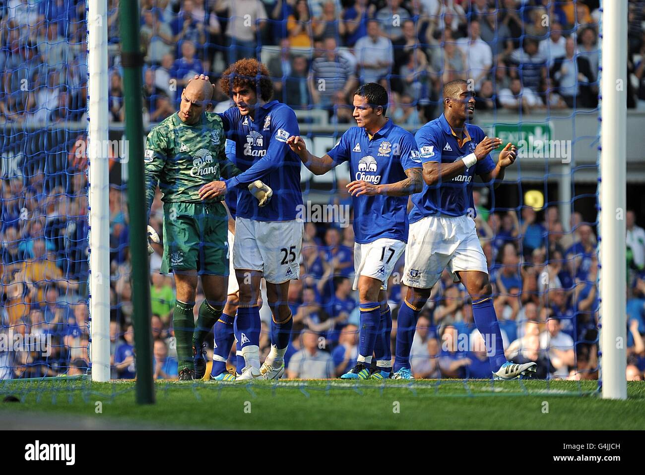 Everton goalkeeper Tim Howard (left) is congratulated by team-mates ...