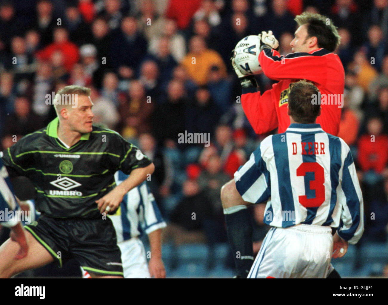 Kilmarnock goalkeeper Gordon Marshall (in red) jumps up to prevent ...