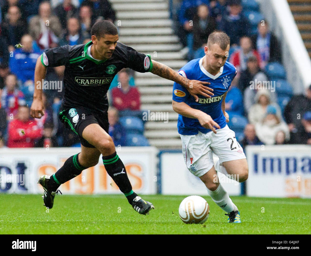 Hibernian's Victor Palsson looks to make the tackle on Rangers' Gregg ...