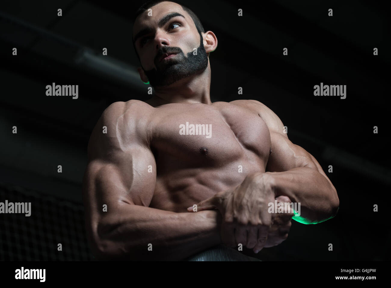 Side Chest Pose Portrait Of A Young Physically Fit Man Performing Side