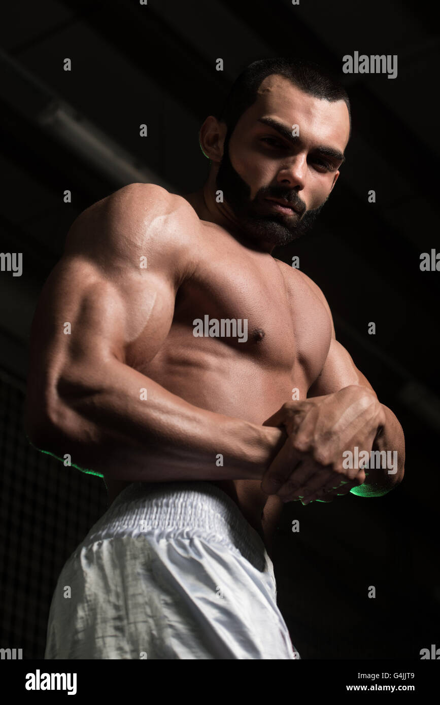 Portrait Of A Young Physically Fit Man Performing Side Chest Pose ...