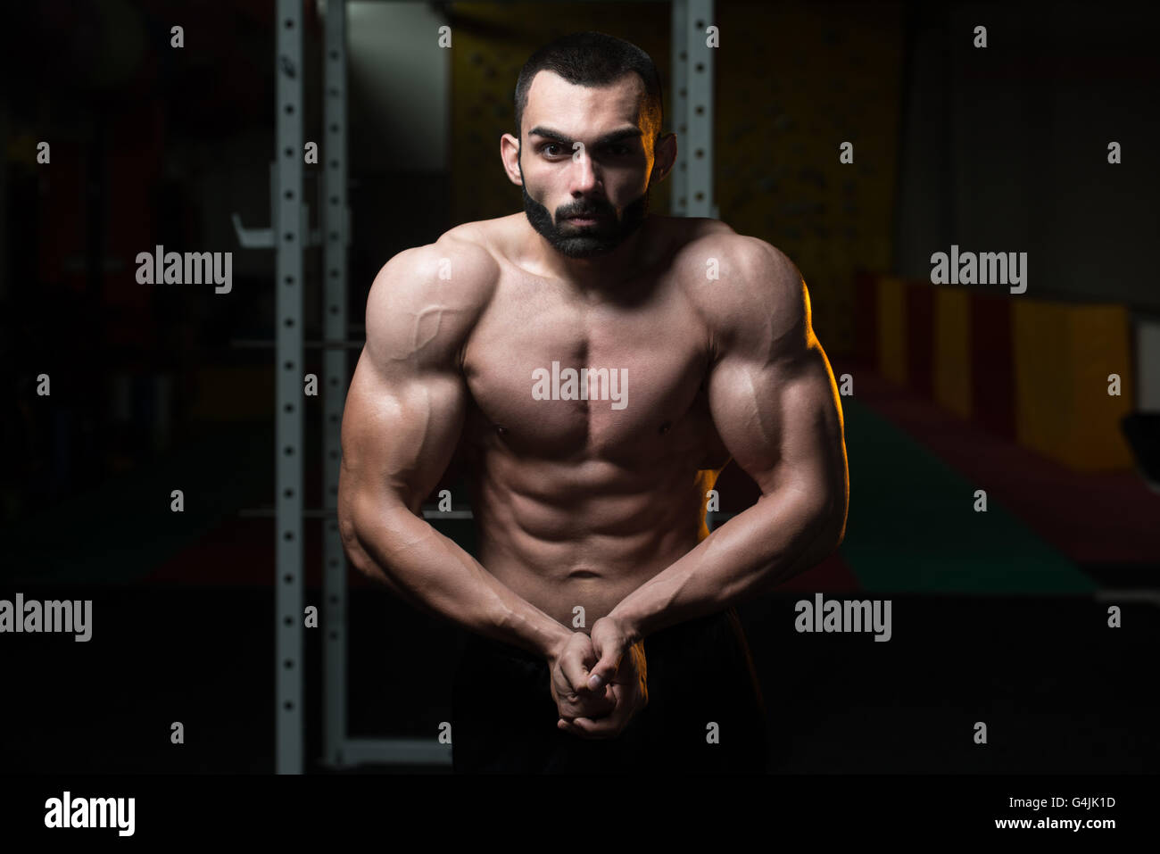 Portrait Of A Young Physically Fit Man Making Most Muscular Pose ...