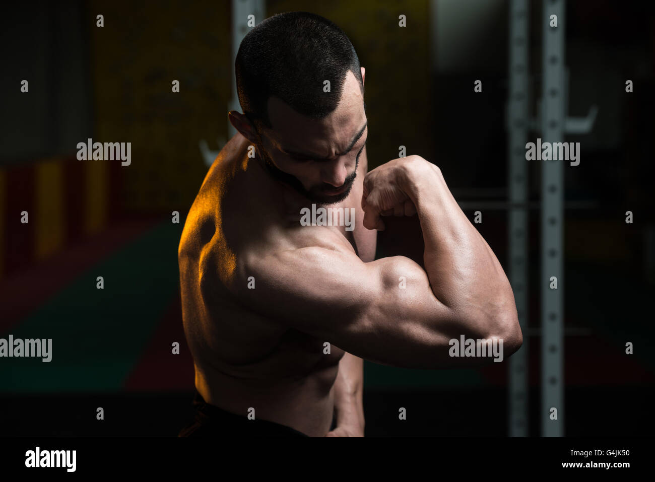 Portrait Of A Young Fit Man Flexing Front Biceps Pose - Muscular ...