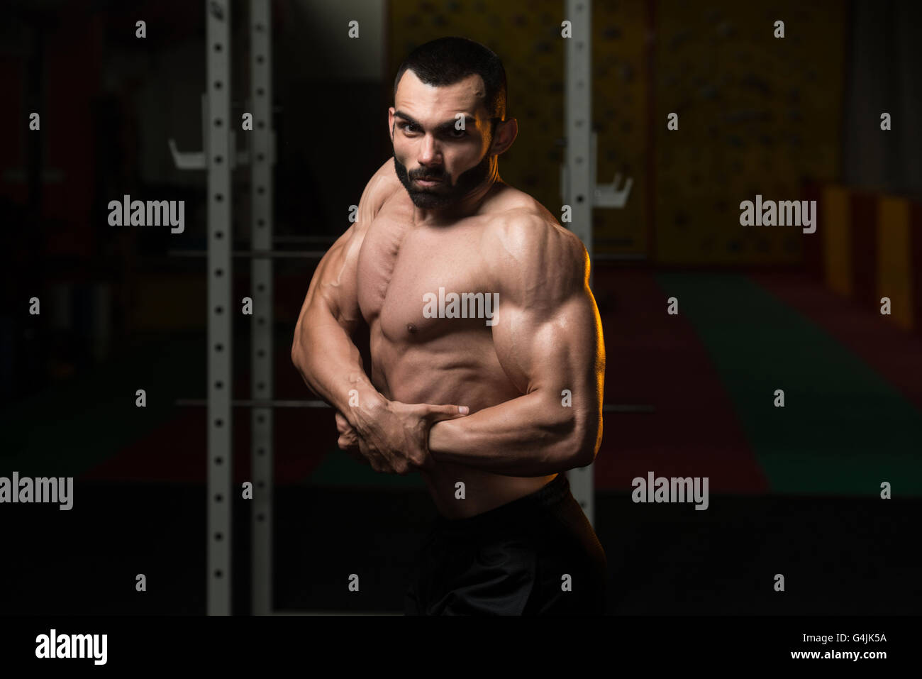 Portrait Of A Young Physically Fit Man Performing Side Chest Pose ...