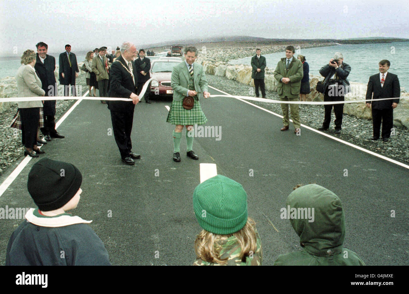 The Prince of Wales cuts the ribbon to open a causeway linking the ...