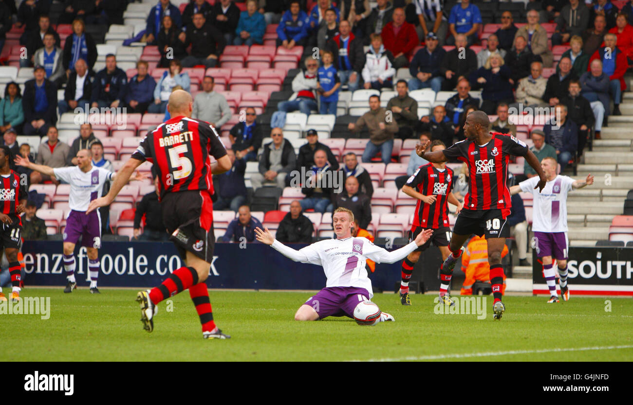 Rochdale's Ashley Grimes (on floor) wins a penaltymafter a tackle by ...